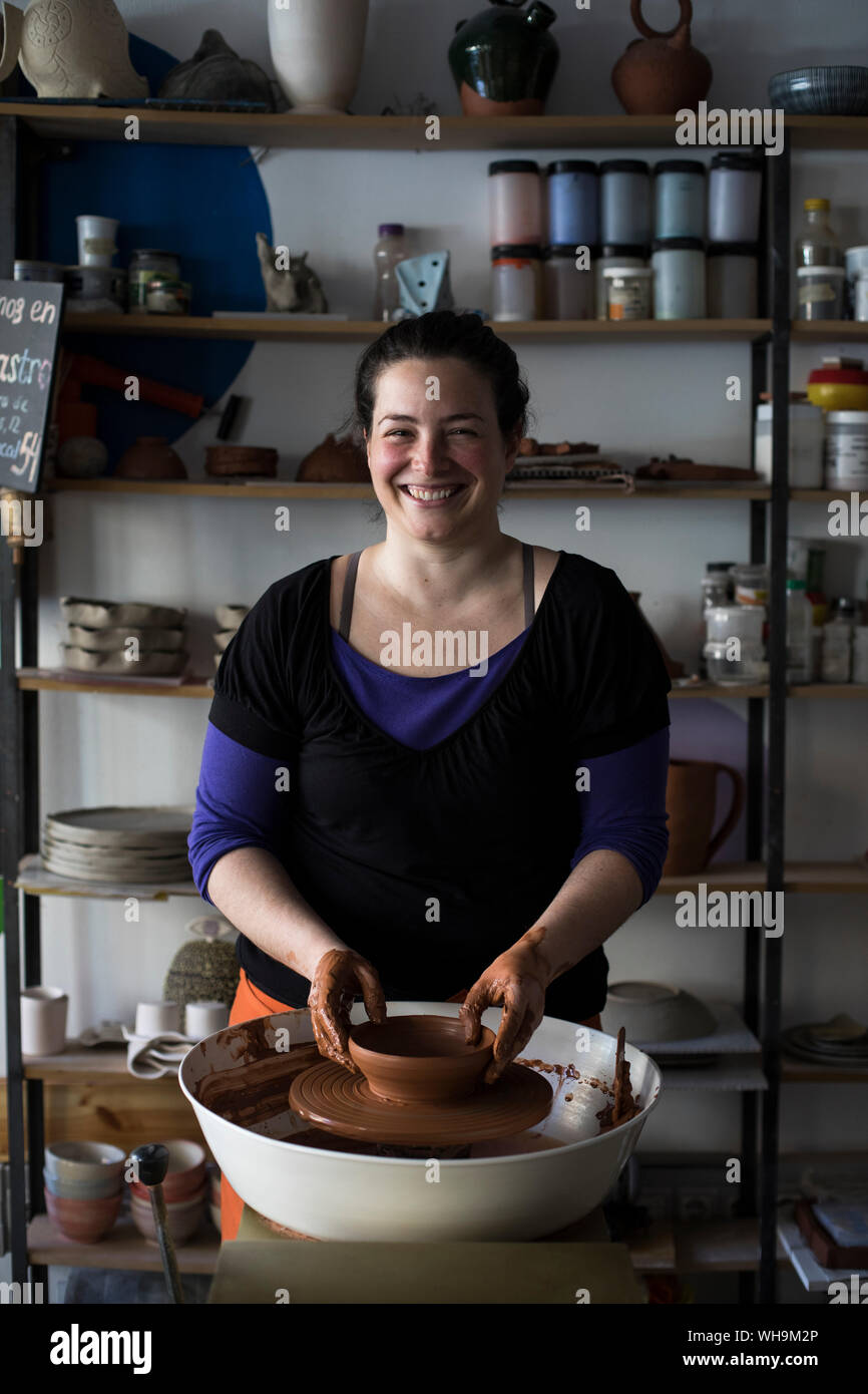 Potter forming clay on a wheel Stock Photo - Alamy