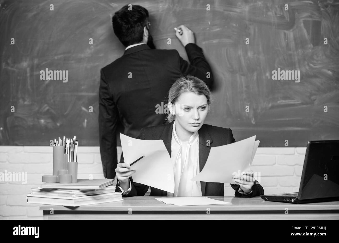 Write down your task. Teachers working in pairs school classroom ...