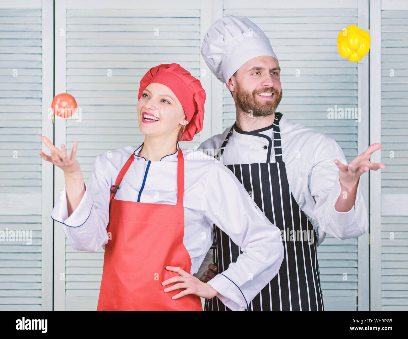 playful culinary master. Family cooking in kitchen. happy couple in ...