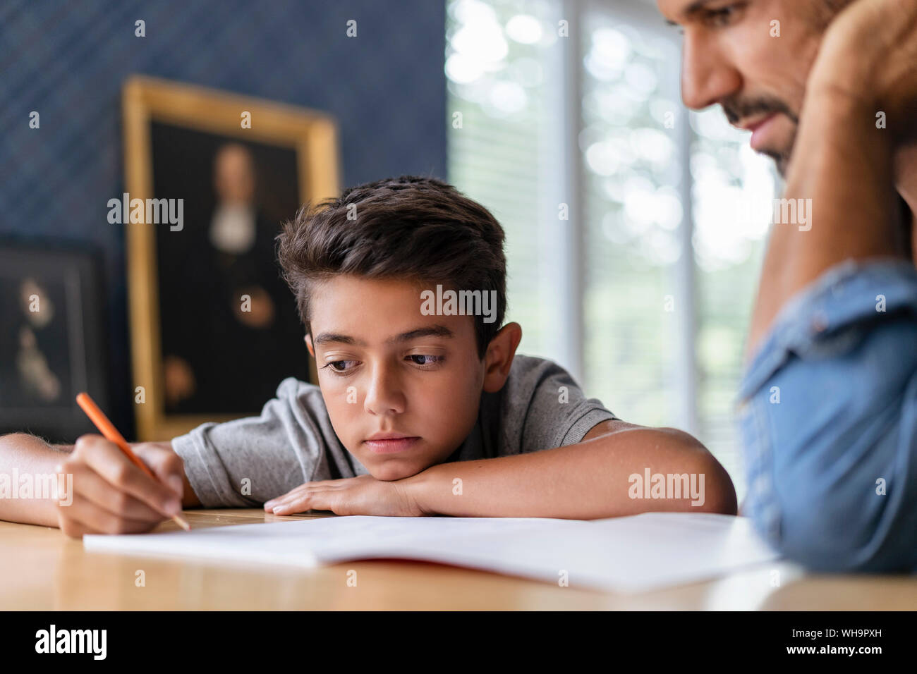 Father helping son doing homework Stock Photo - Alamy