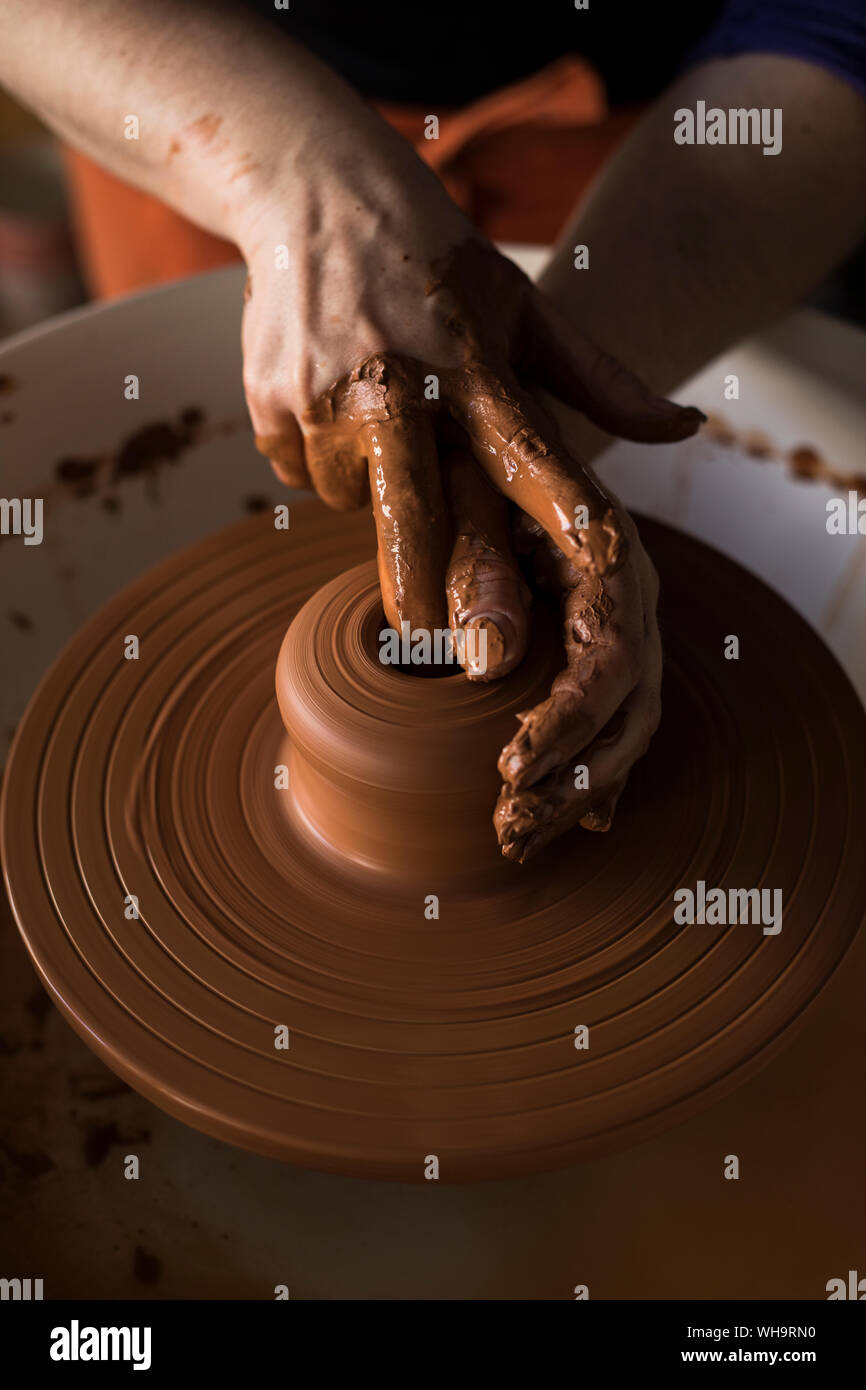 Potter forming clay on a wheel Stock Photo - Alamy