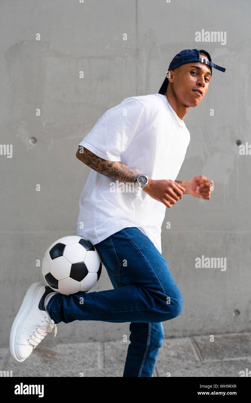 Balancing football on leg hi-res stock photography and images - Alamy
