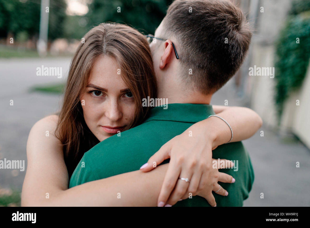 Woman hugging man shoulders hi-res stock photography and images - Alamy