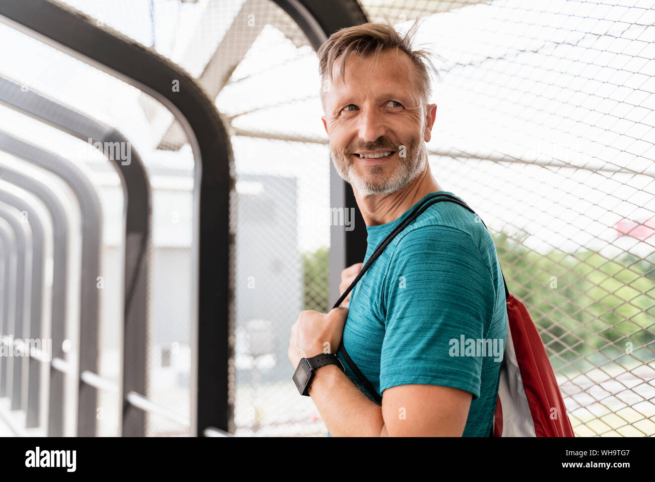 Sporty man carrying a pouch Stock Photo - Alamy