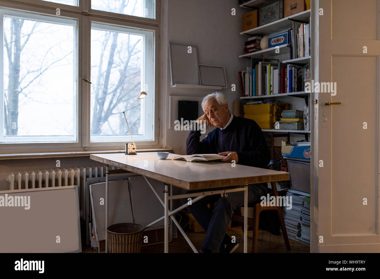Home alone man reading hi-res stock photography and images - Alamy