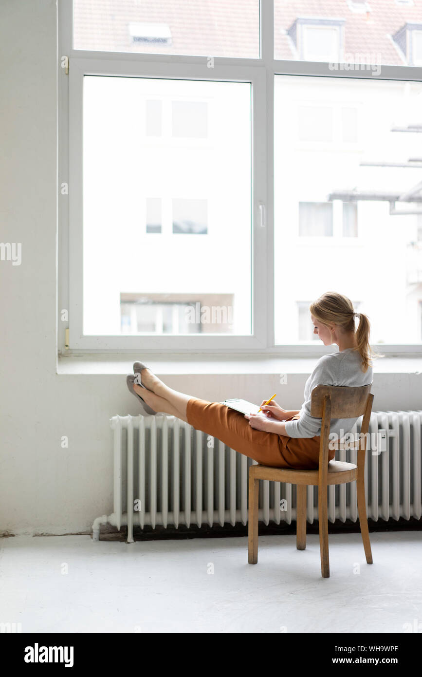 Woman feet up and woman taking notes hi-res stock photography and ...