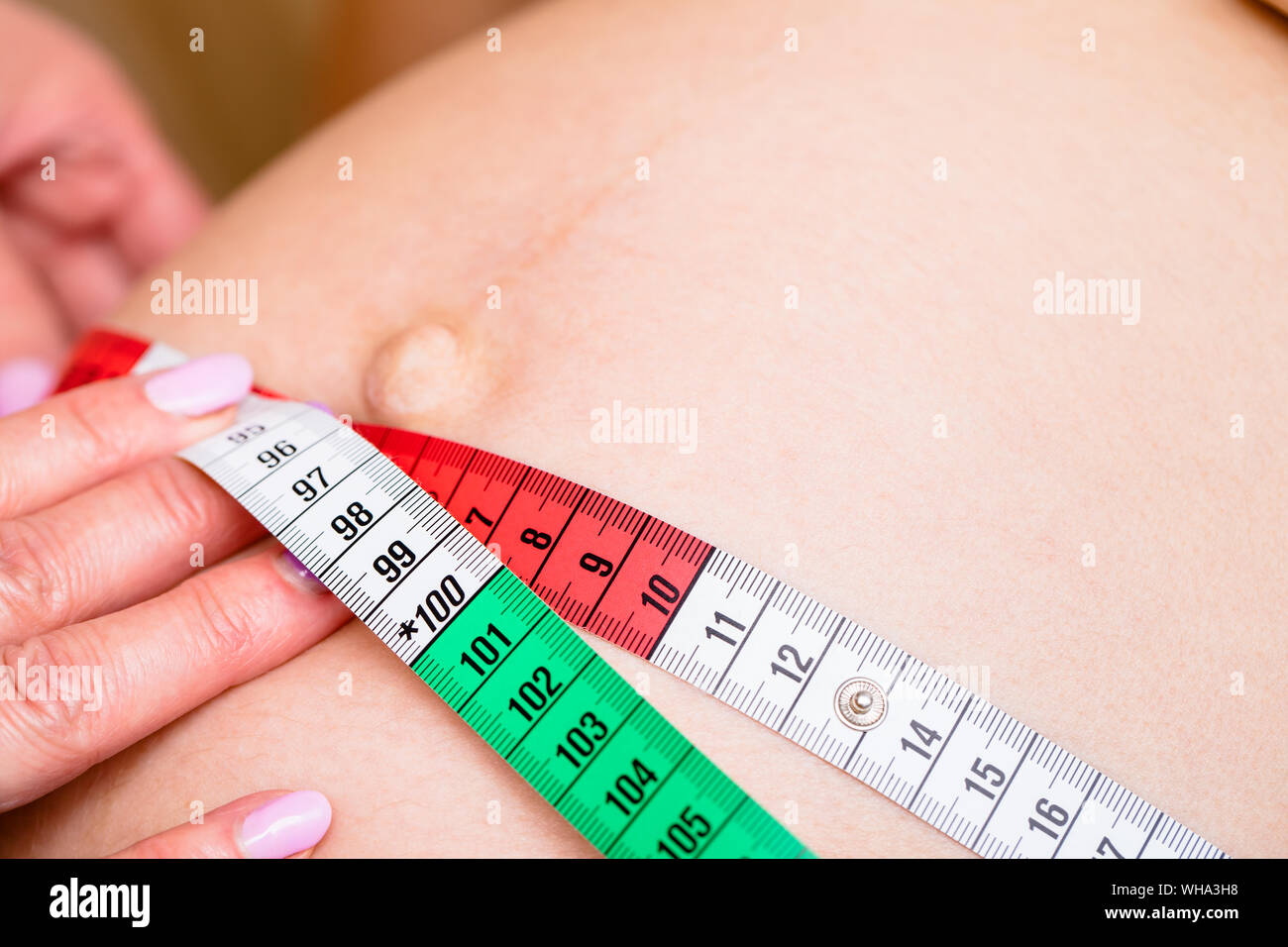 Close-up shot of obstetrician gynecologist measuring pregnant woman's ...
