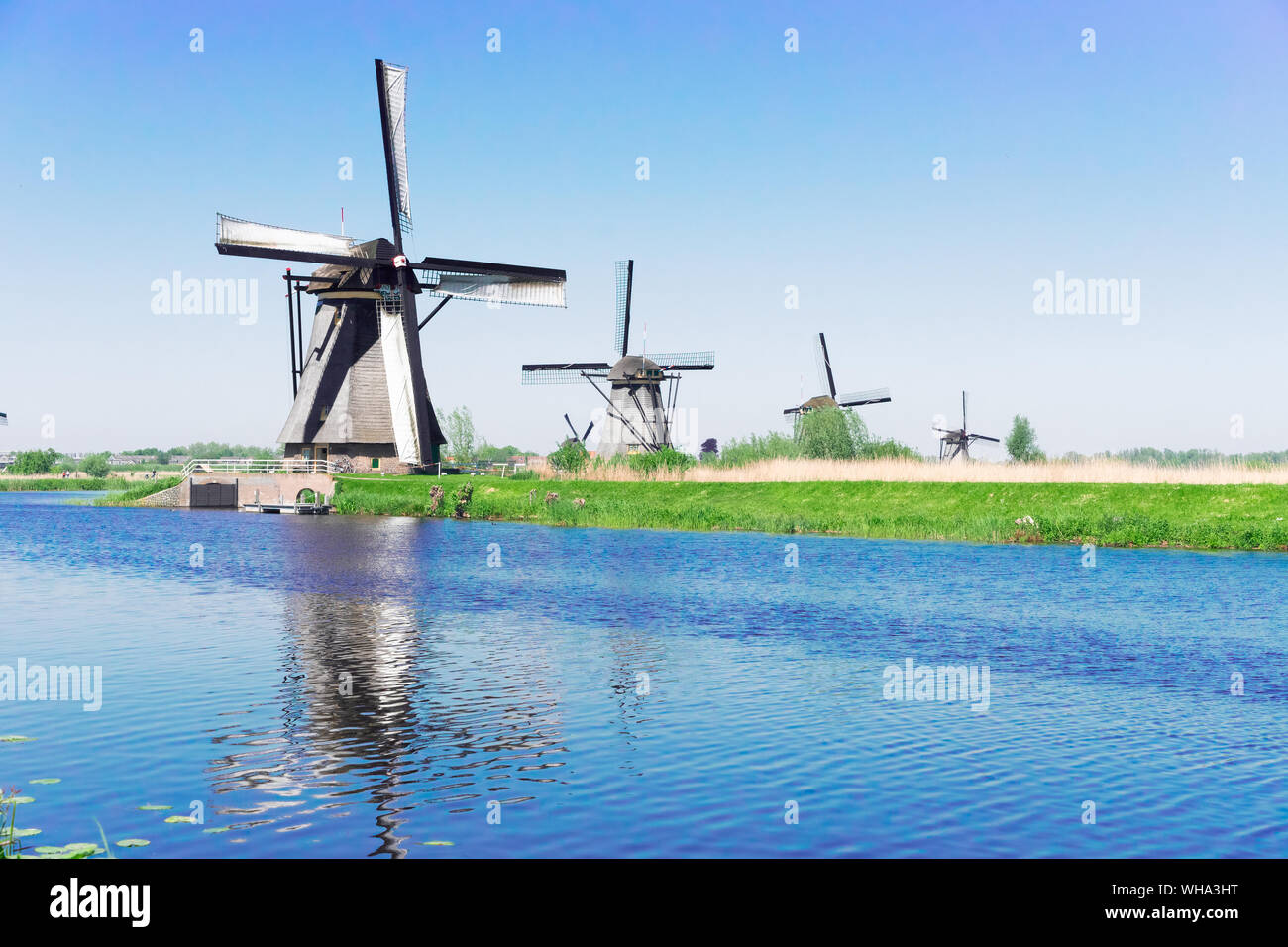 dutch windmill over river waters Stock Photo - Alamy