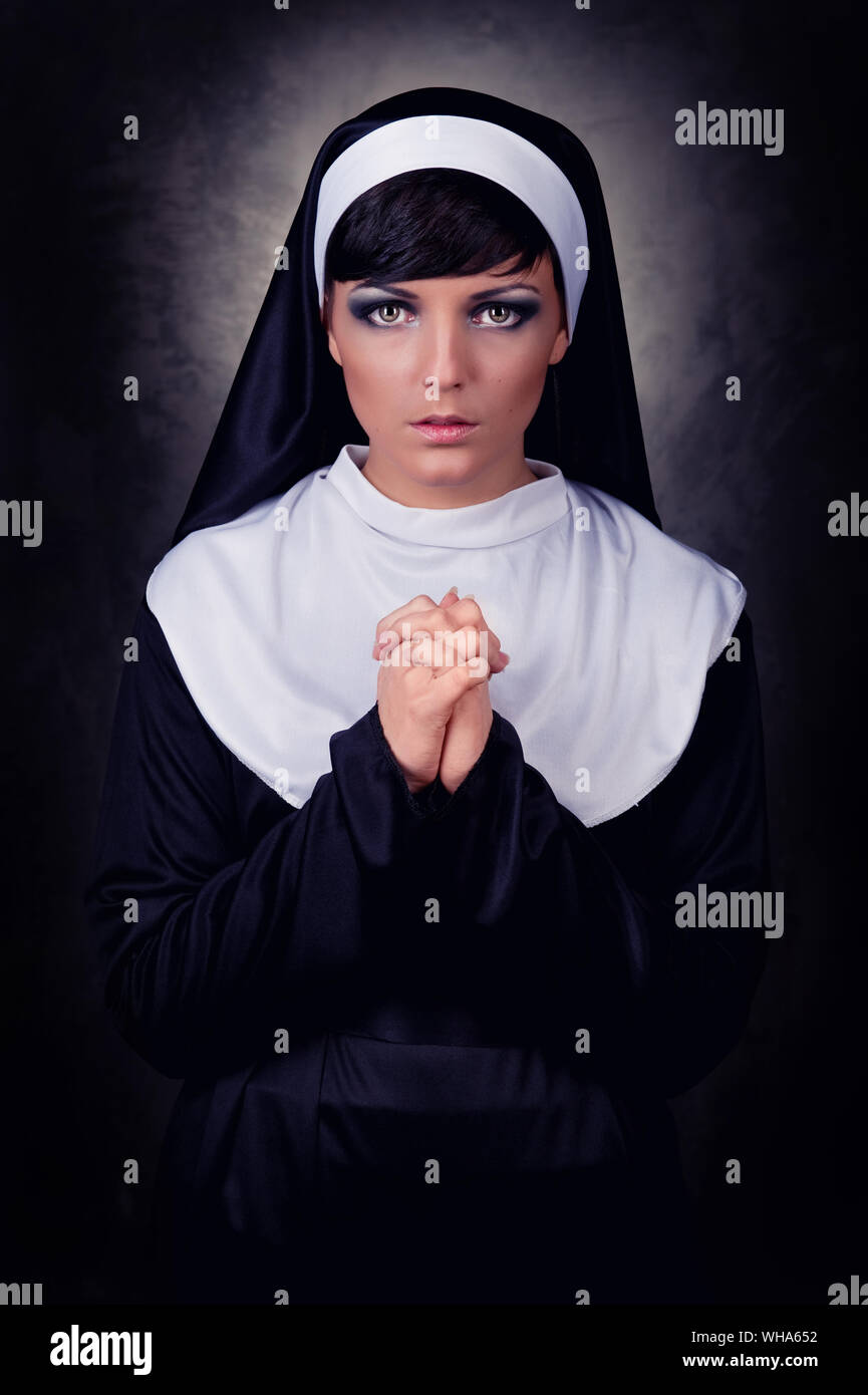 Young nun praying hi-res stock photography and images - Alamy