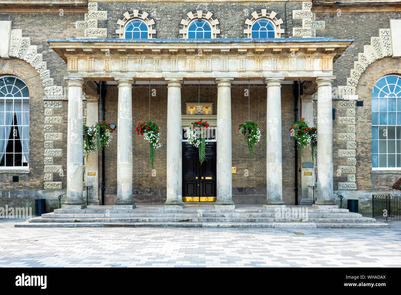 Hanging baskets of flowers between pillars at front of Salisbury ...