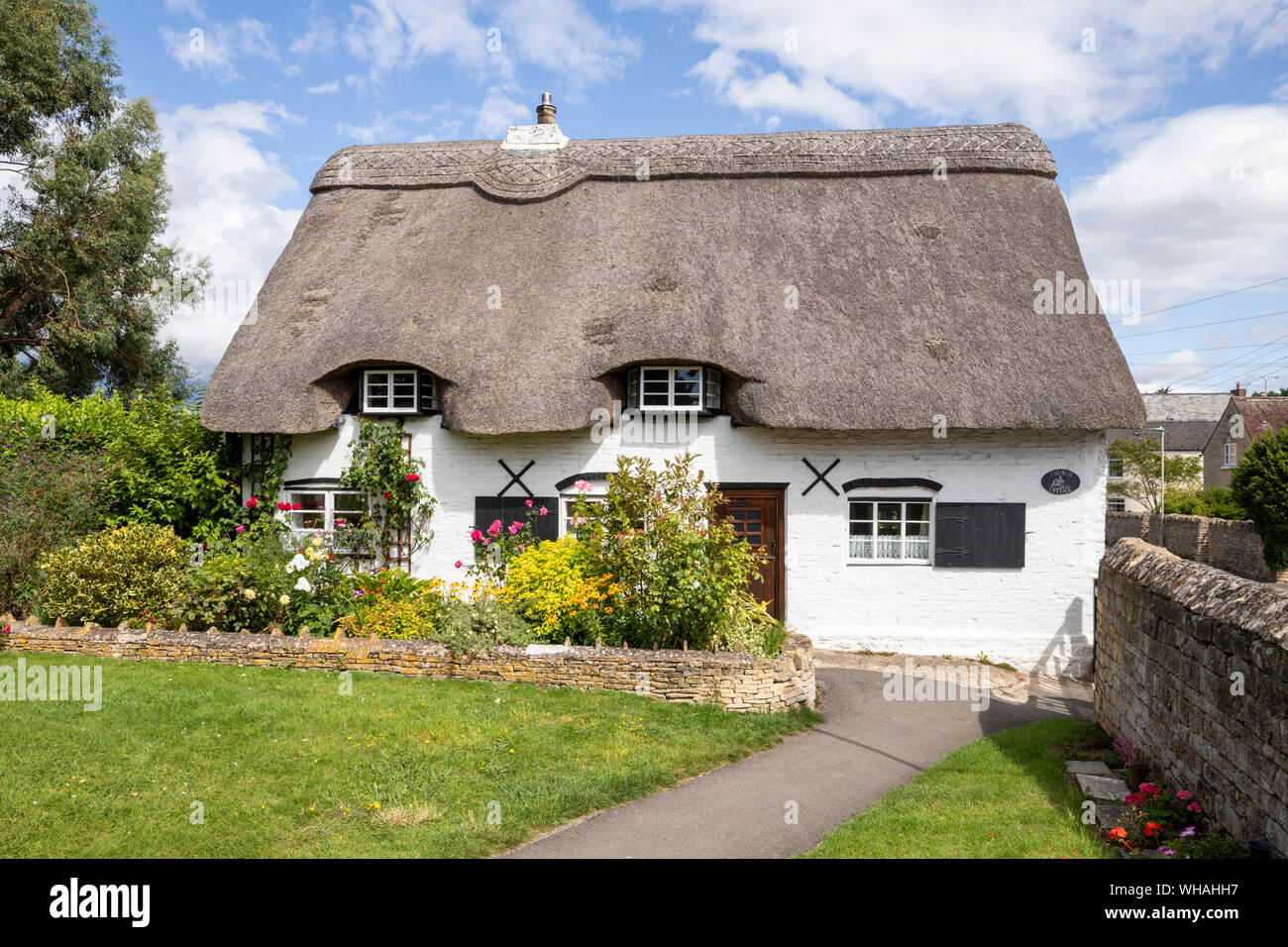 The delightful, thatched Church Cottage in a corner of the churchyard ...