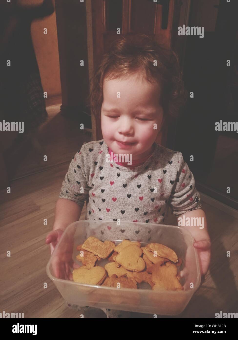Girl Holding Cookies In Container At Home Stock Photo - Alamy