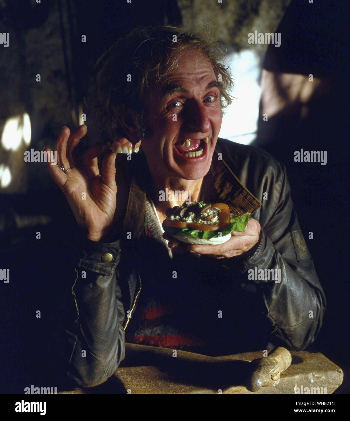 Man taking his teeth out before eating Stock Photo - Alamy
