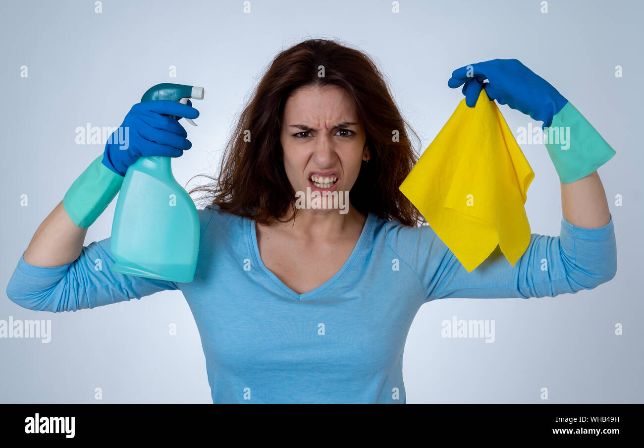 Beautiful angry and upset woman holding mop and cleaning spray feeling ...
