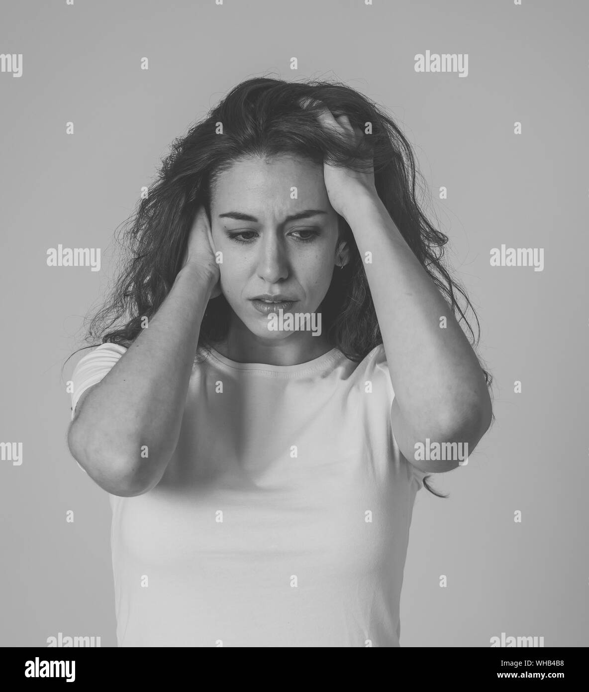 Portrait of young sad woman looking worried in emotional pain. Feeling ...