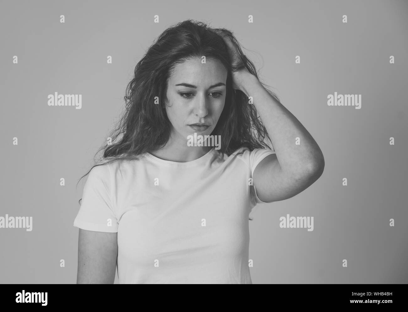 Portrait of young sad woman looking worried in emotional pain. Feeling ...