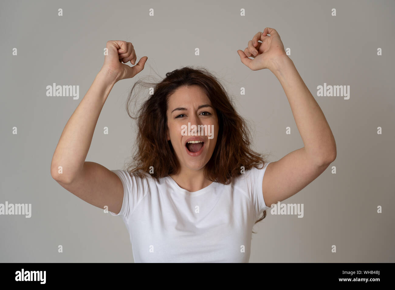 Portrait of beautiful shocked woman winning or having great success ...