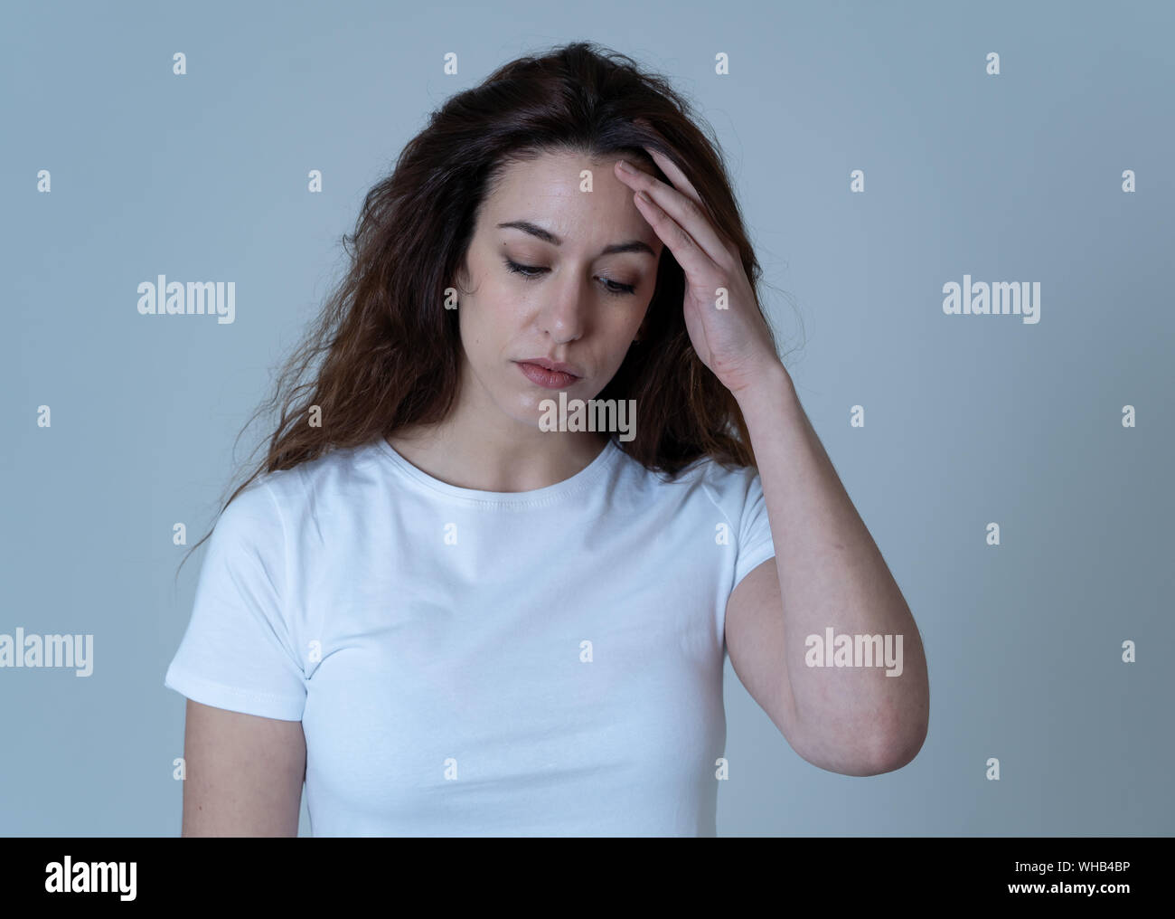 Portrait of young sad woman looking worried in emotional pain. Feeling ...