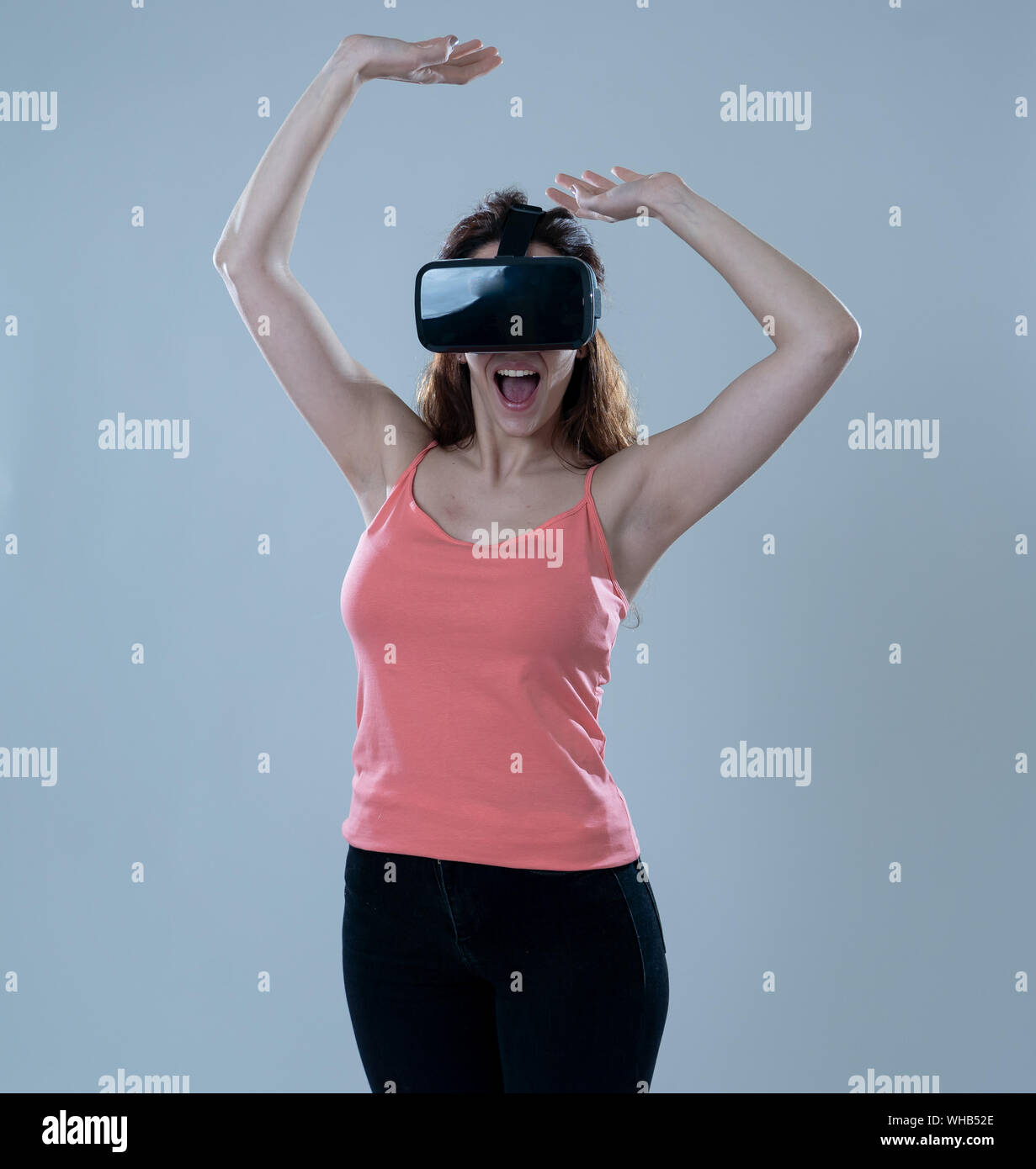 Curious woman happy and excited to use virtual reality goggles feeling ...