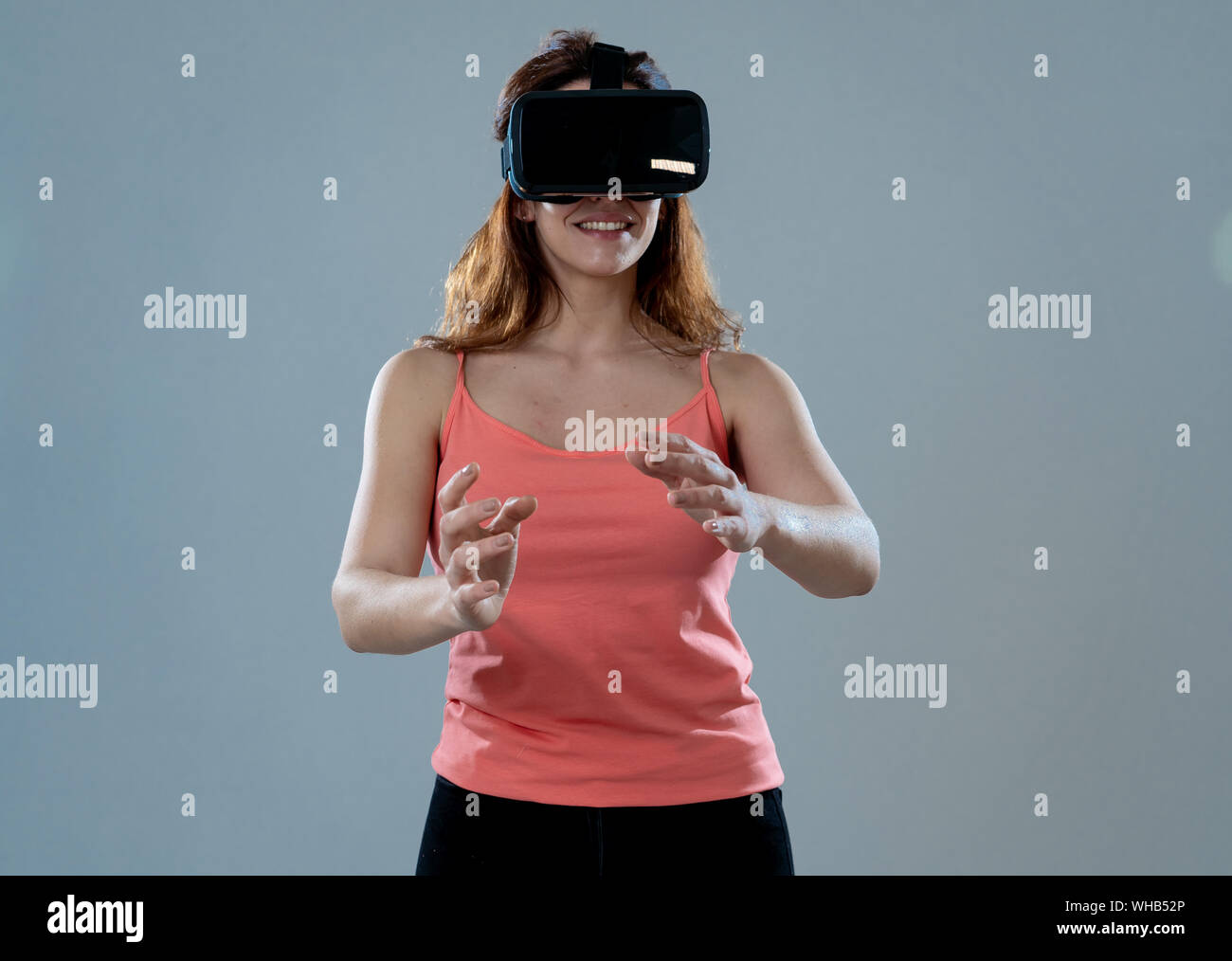 Amazed attractive woman using VR headset glasses touching and ...