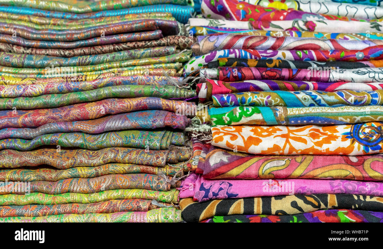 Bright cashmere shawls in the bazaar. Background with oriental shawls ...