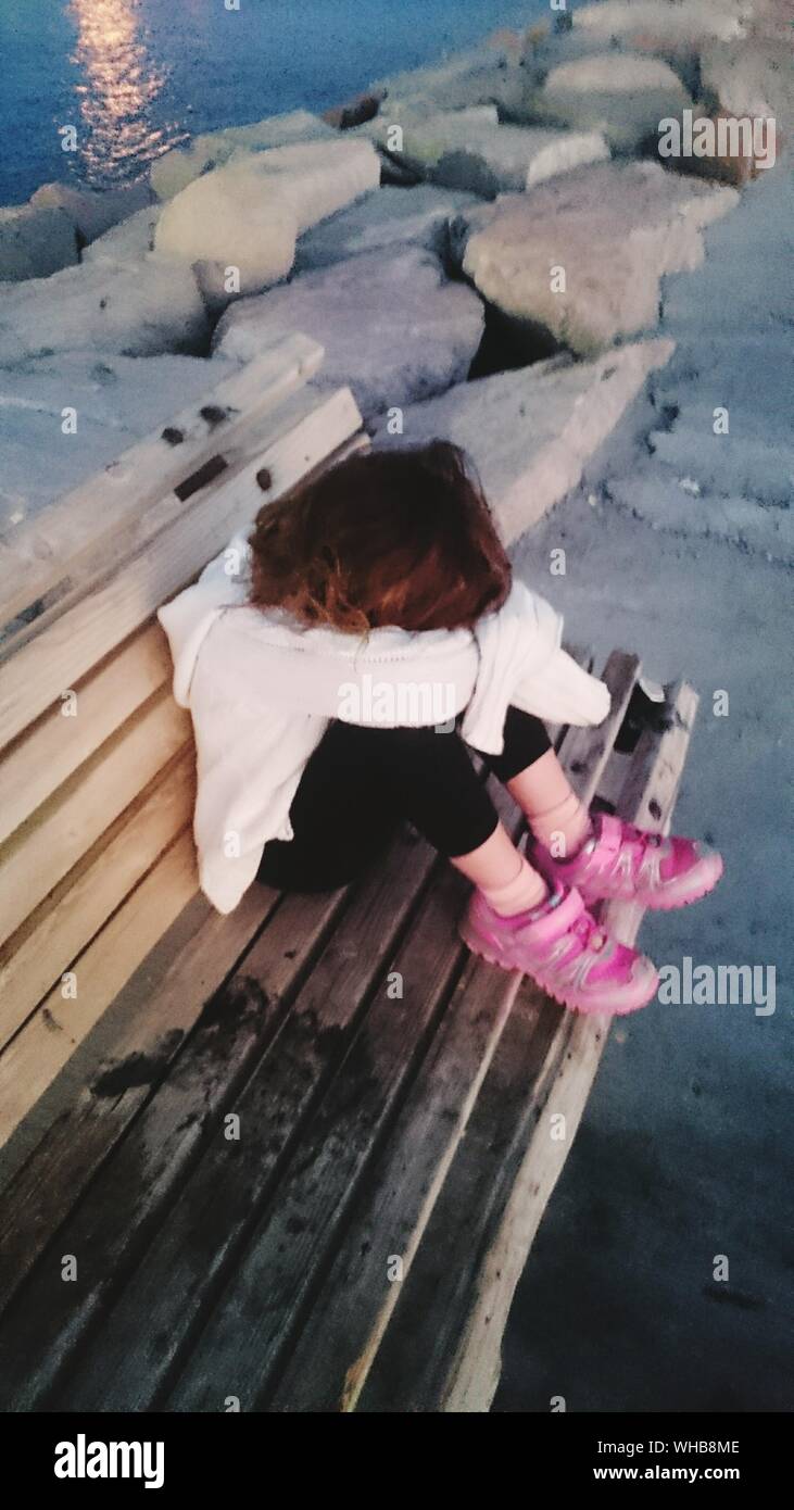 Sad girl sitting on bench hi-res stock photography and images - Alamy