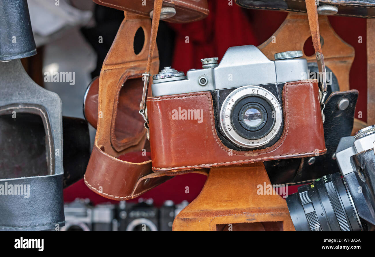 Vintage camera in a brown leather case. Old camera at a flea market ...