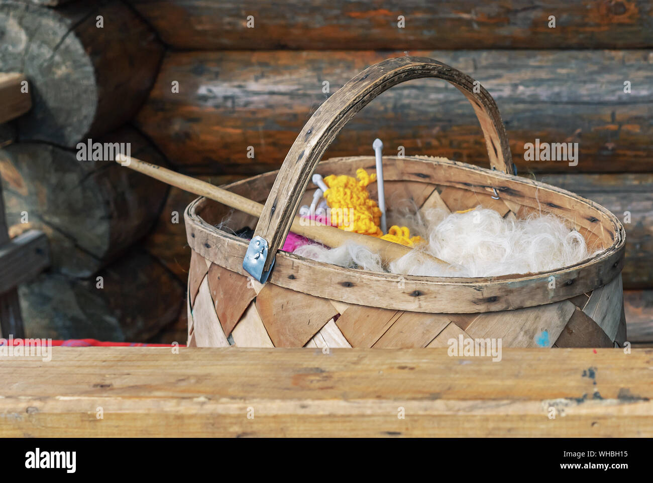 Wicker basket with yarn and spindle for manual spinning of a woolen ...