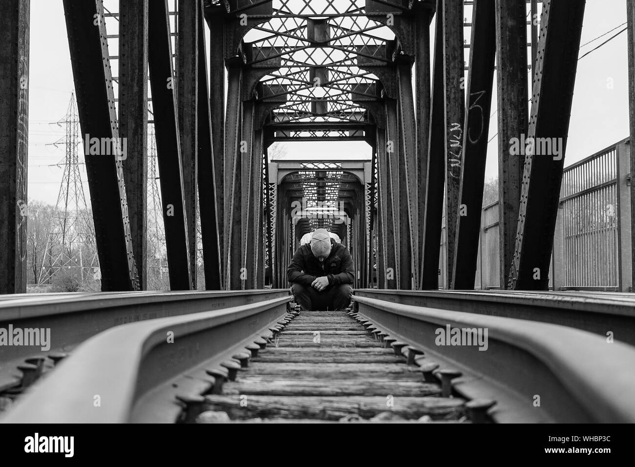 Person Sitting On Railroad Tracks Stock Photo - Alamy