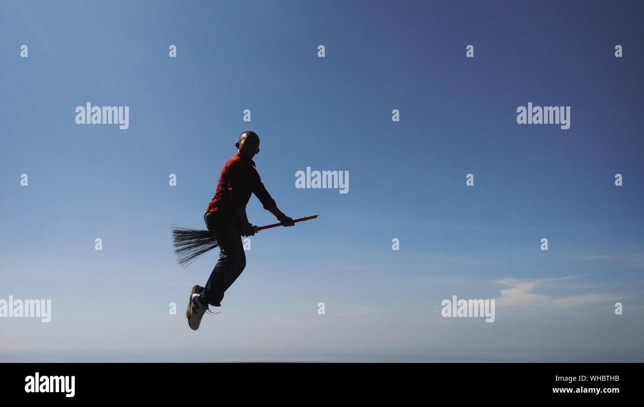 Person holding a broom hi-res stock photography and images - Alamy