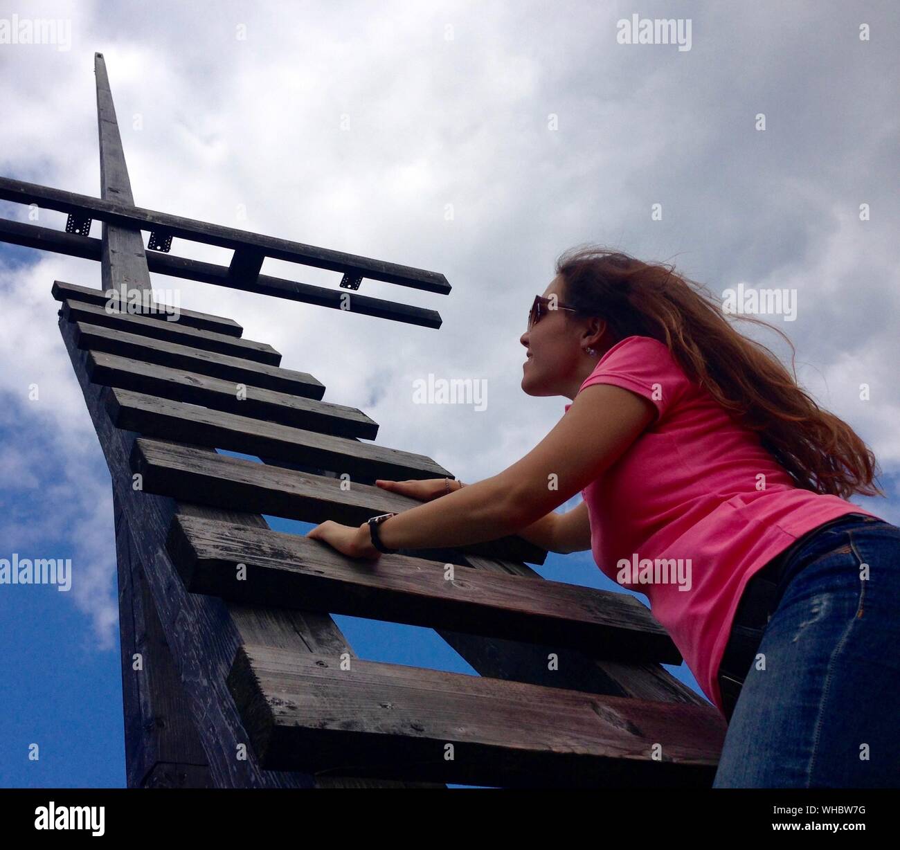 Woman climbing ladder hi-res stock photography and images - Alamy