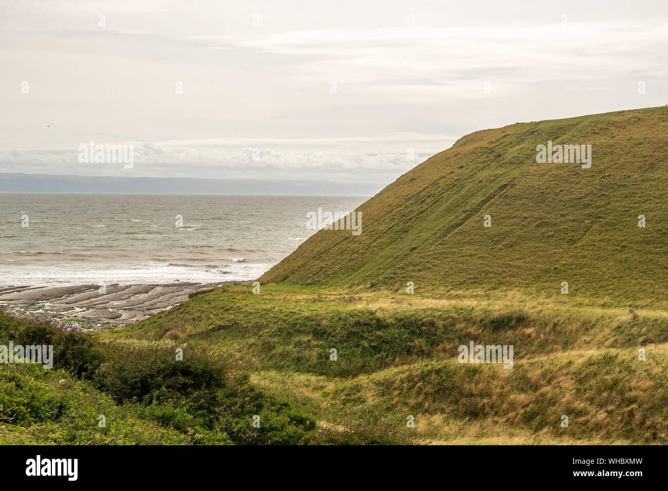 Coast with beach and monuments, Wales Stock Photo - Alamy