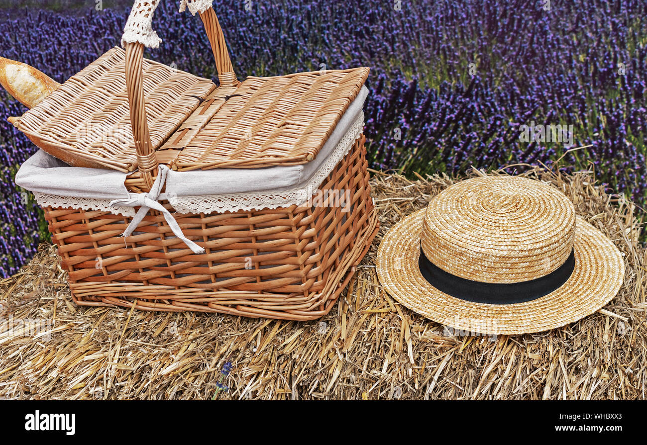Straw hat and wicker basket on hay. Rustic design for design and ...