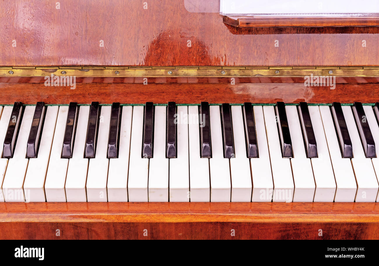 Keyboard on a brown piano. Black and white keys on the keyboard of the ...