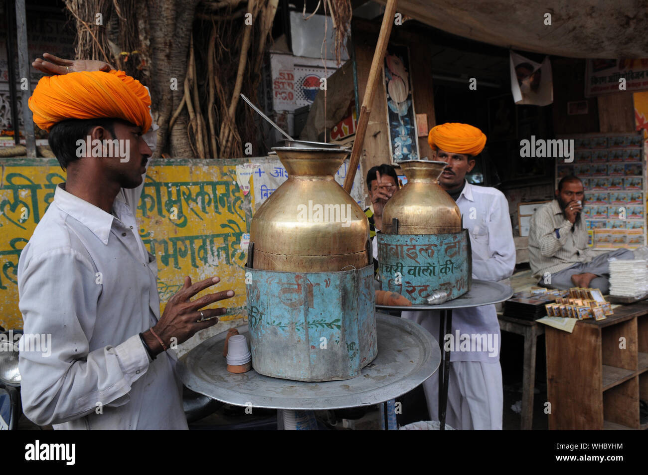 Turbaned tea sellers with their traditional brass containers stand in a ...