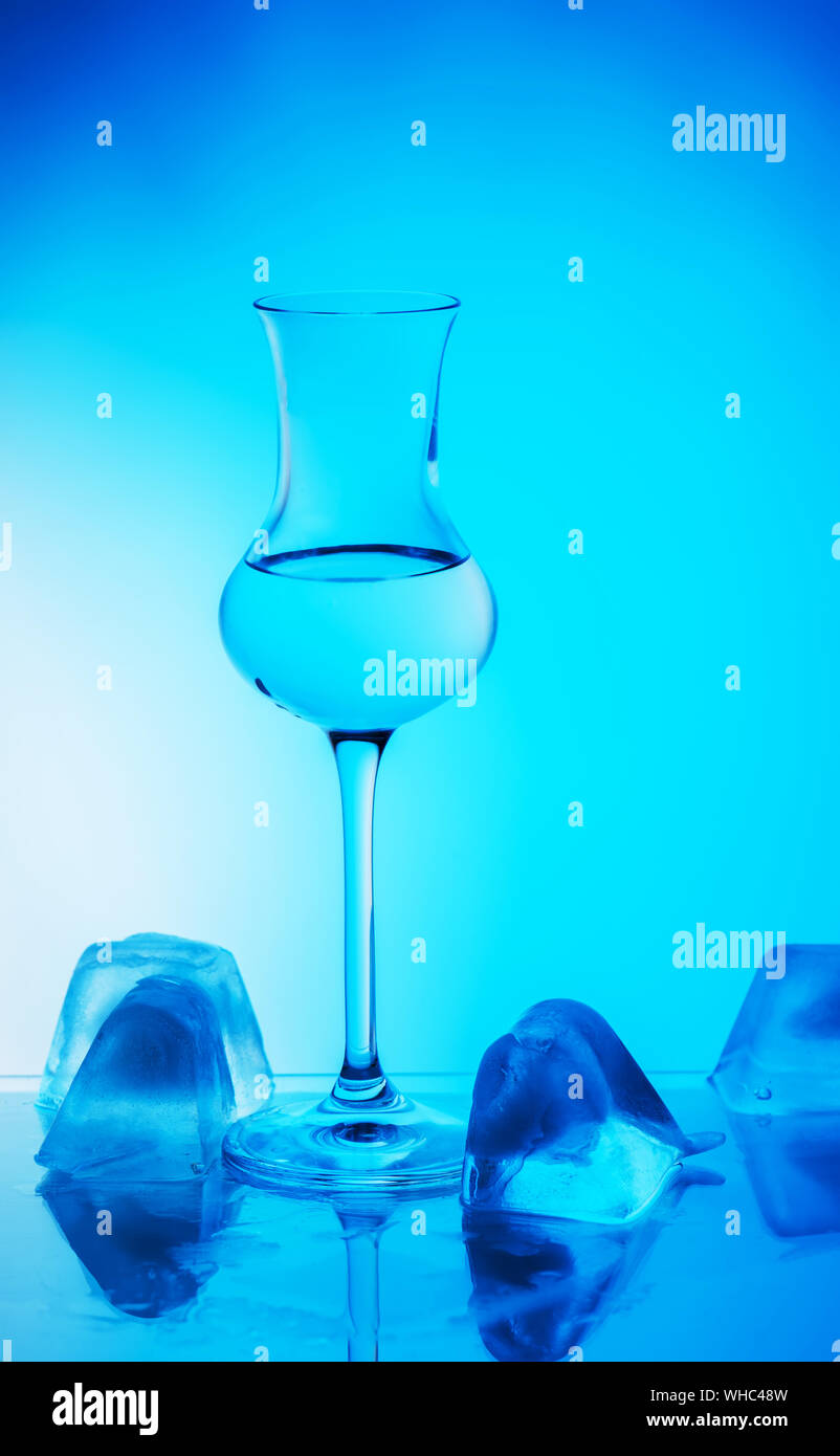 Beautiful elegant and classical glass with grappa with ice in the ...