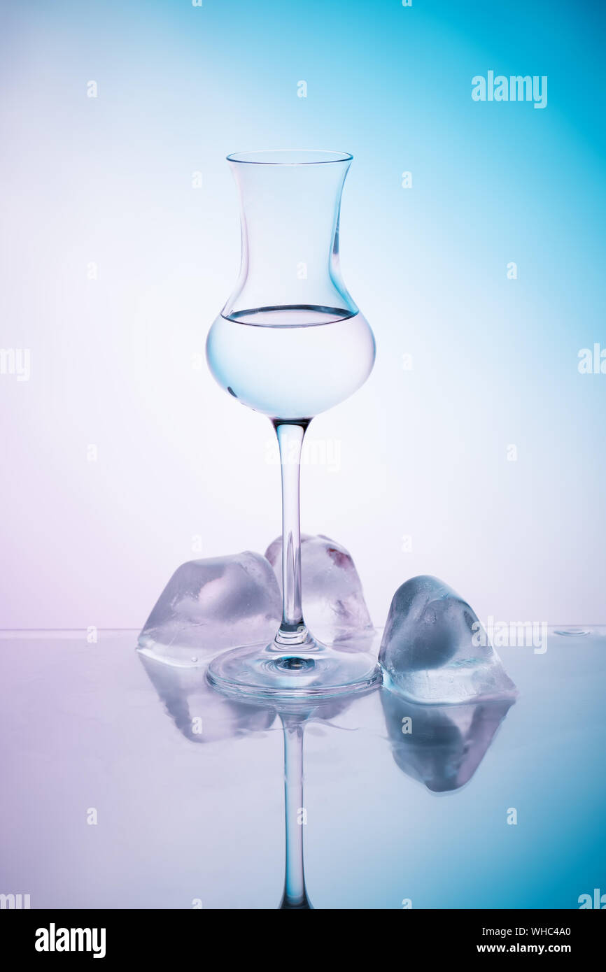 Beautiful elegant and classical glass with grappa with ice in the ...