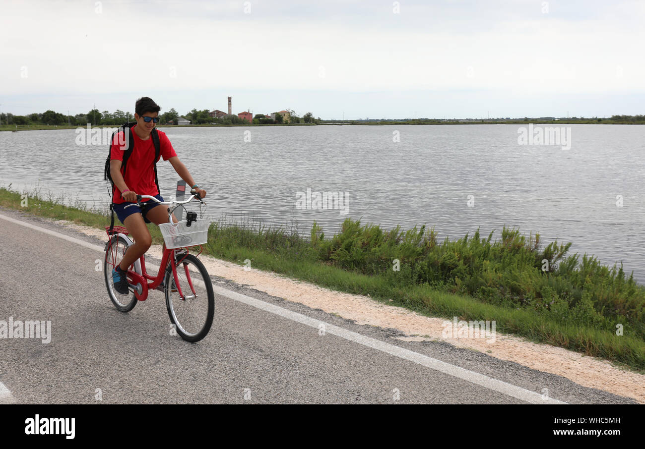 young boy rides bike on the road in Summer Stock Photo - Alamy