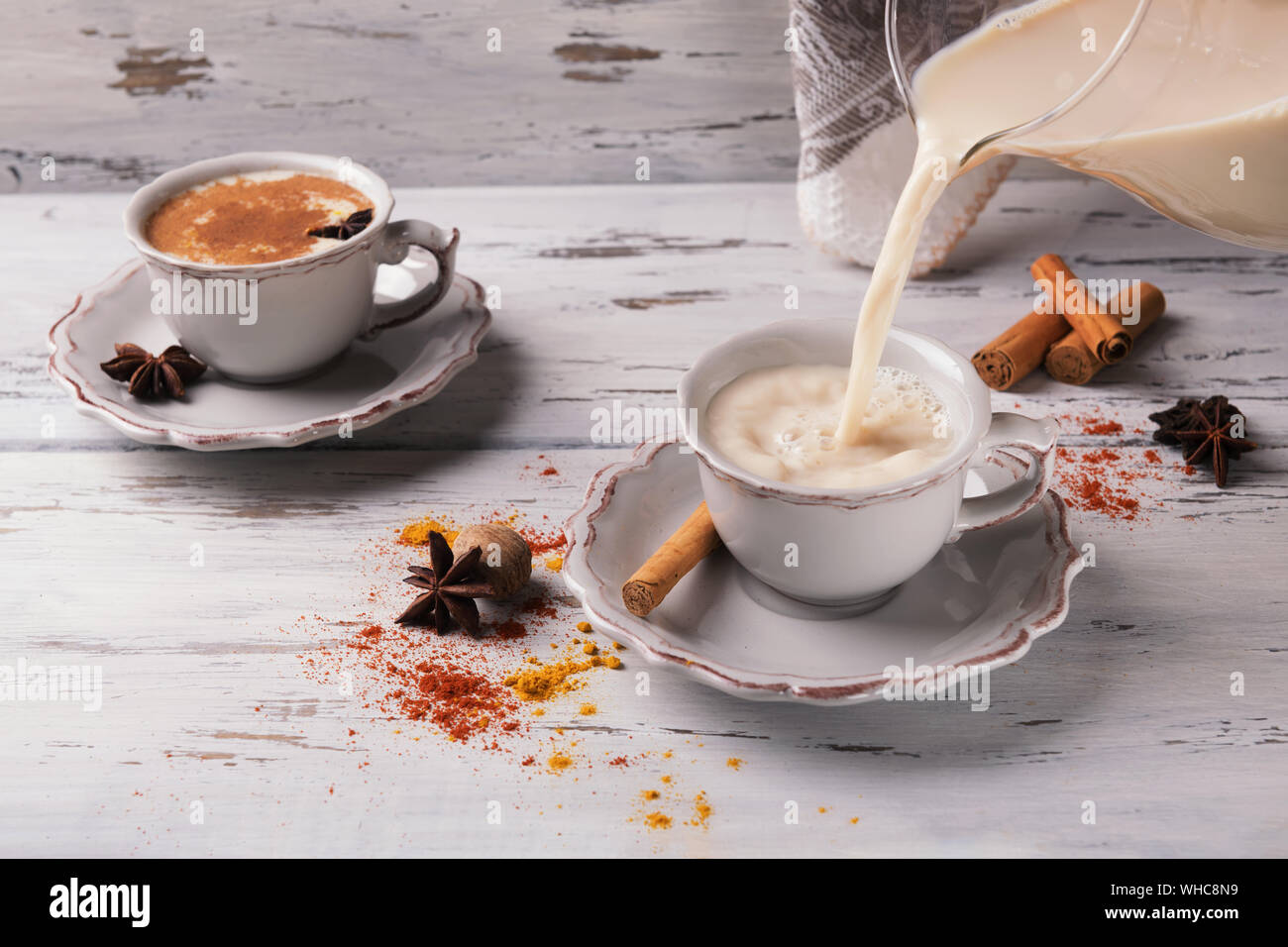 traditional indian masala chai tea pour in a beautiful cup on a shabby ...