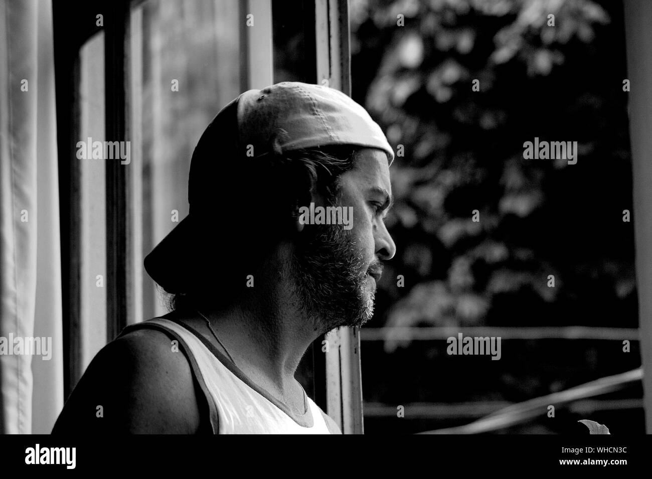 Man looking through window Black and White Stock Photos & Images - Alamy
