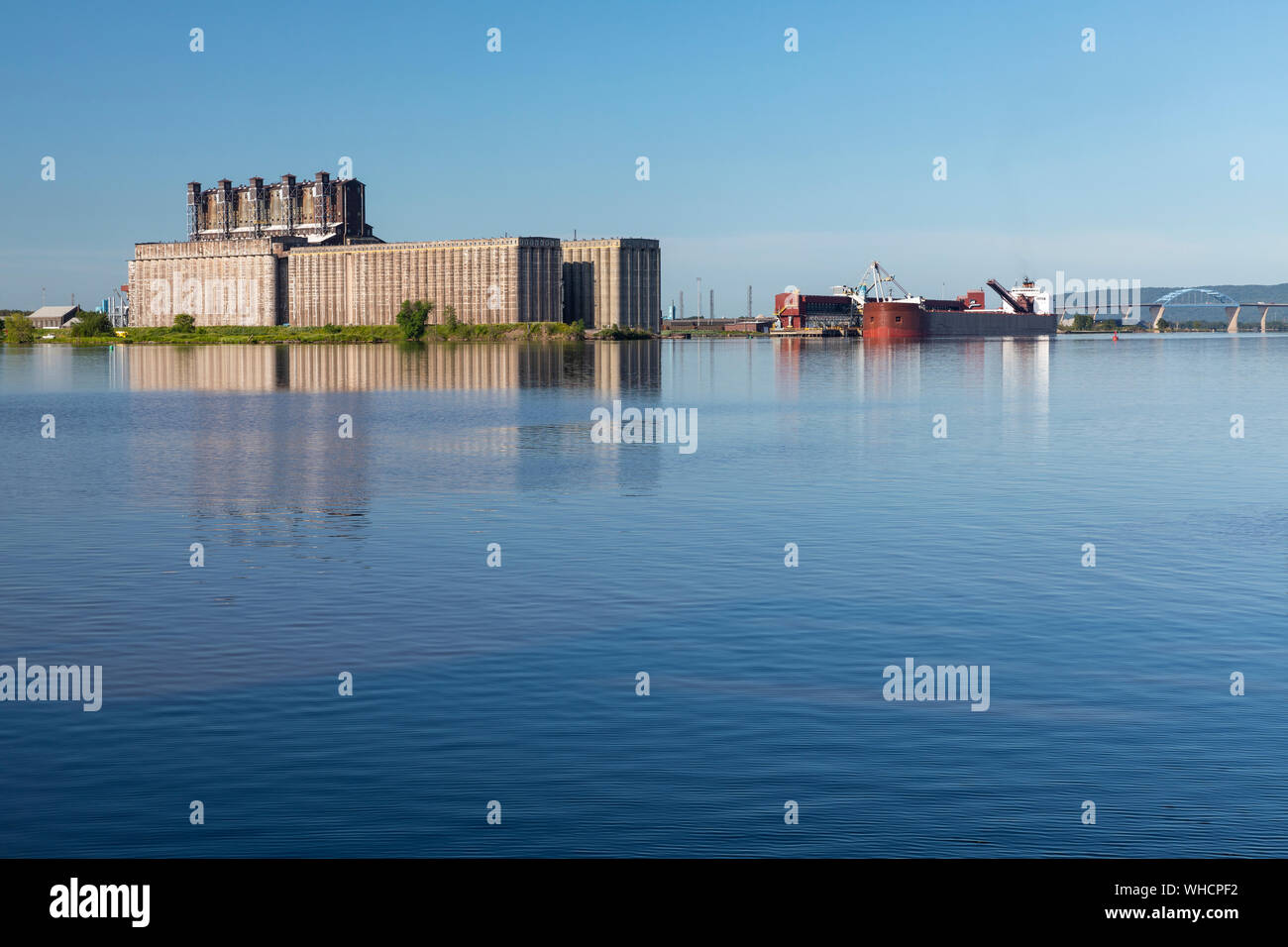 A commercial shipping harbor with a ship being loaded with coal Stock ...