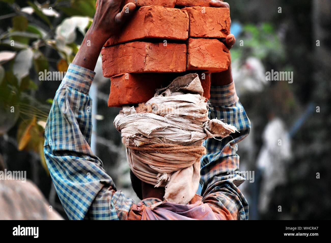 Carrying bricks on their head hi-res stock photography and images - Alamy