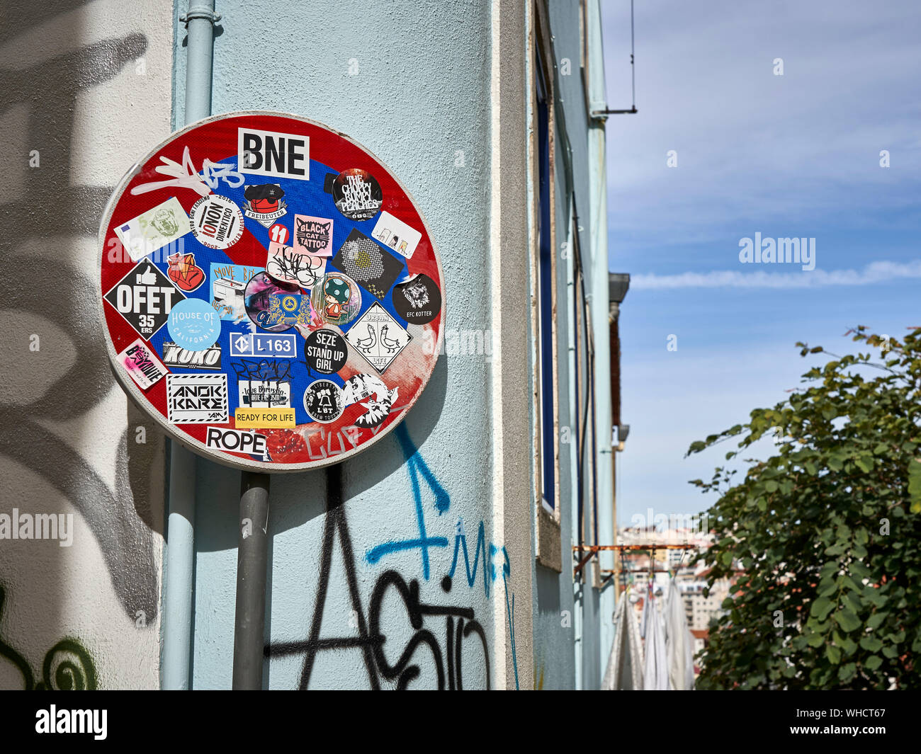 Street sign covered in stickers Lisbon Portugal Stock Photo - Alamy