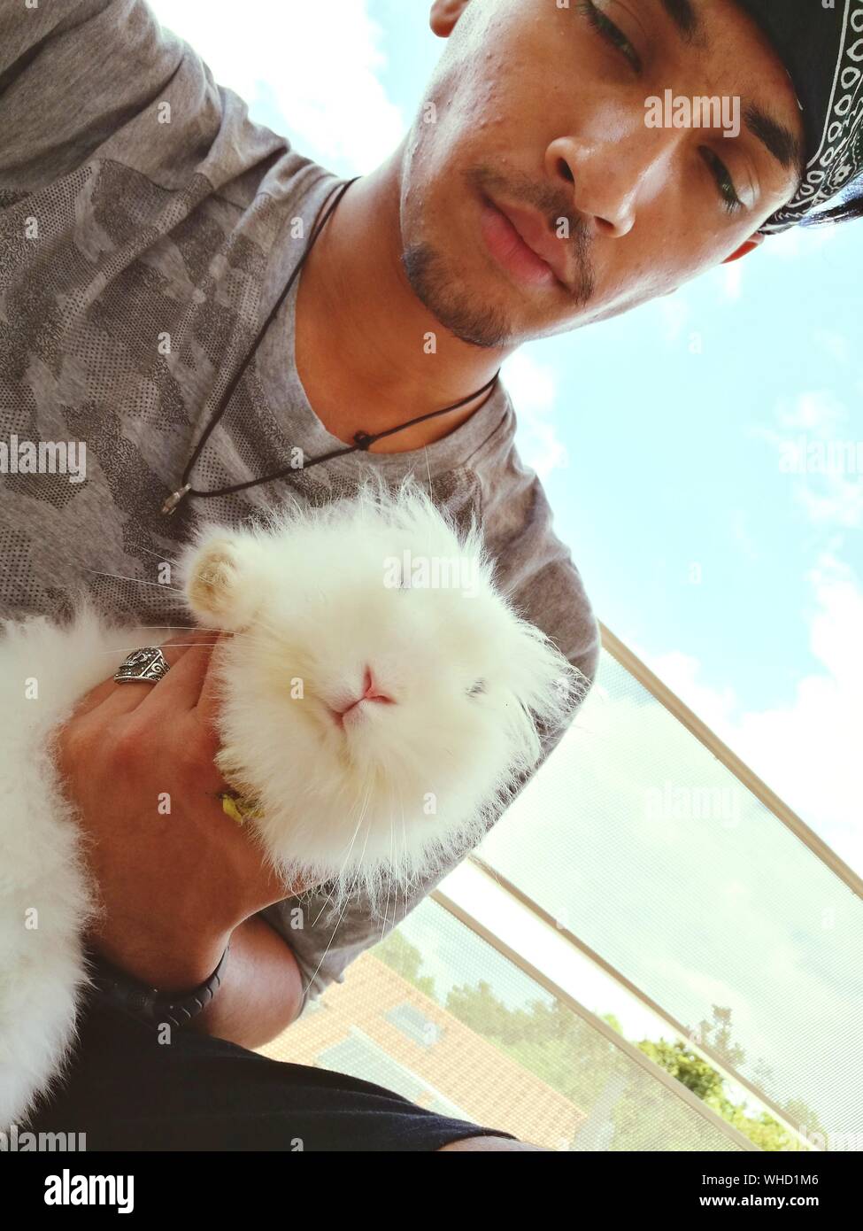 Man holding rabbit outdoors hi-res stock photography and images - Alamy