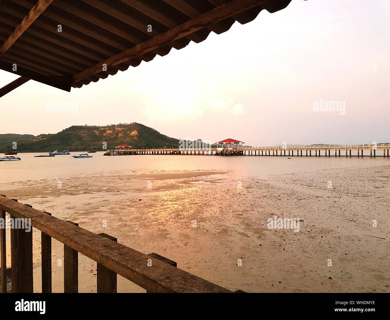 Pier on beach at sunset hi-res stock photography and images - Alamy