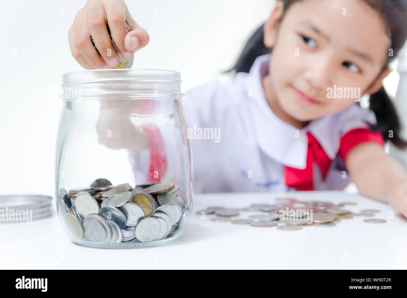 Child putting coins into hi-res stock photography and images - Alamy