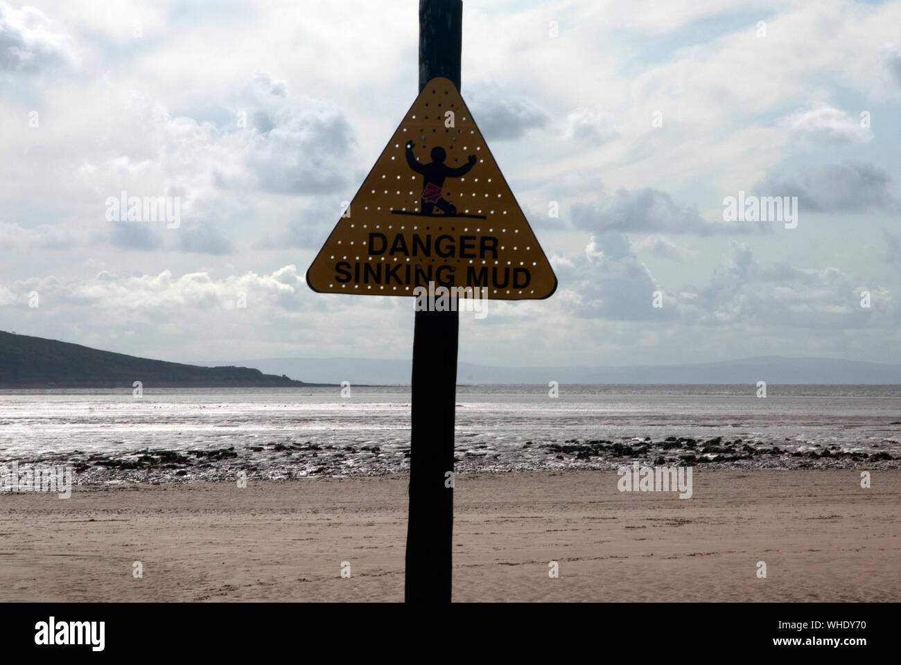 Warning sign about the danger of sinking sands on the mudflats at ...