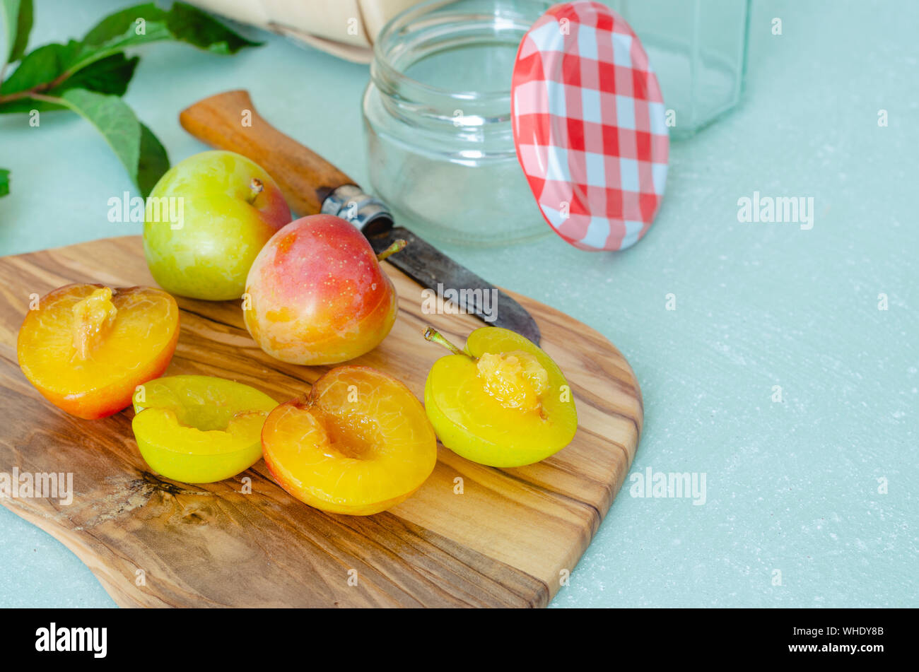 Plums cut on kitchen board. Fresh fruit prepared Stock Photo - Alamy