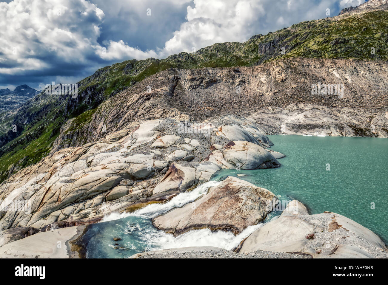 lake and waterfall on rhone glacier between swiss alps, switzerland ...