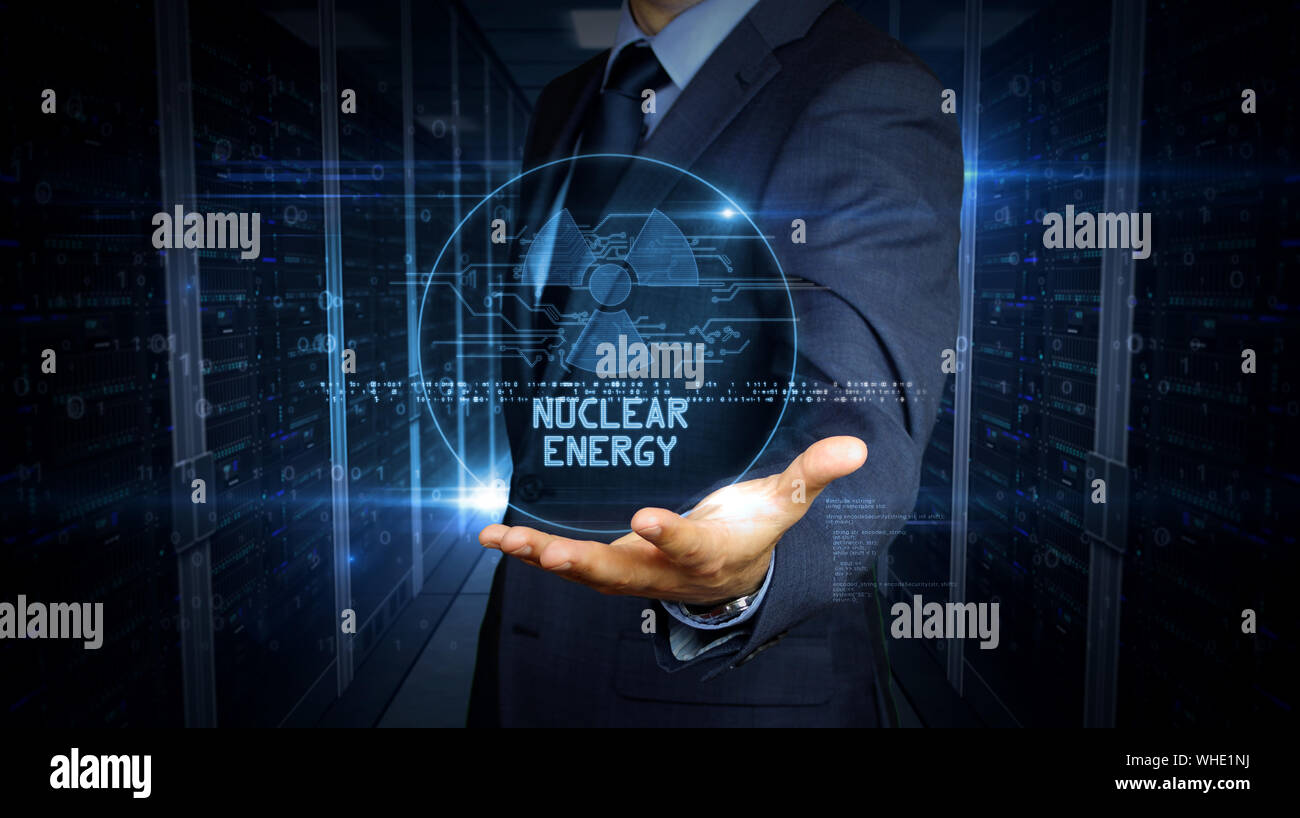 A businessman in a suit touch screen with nuclear energy symbol ...